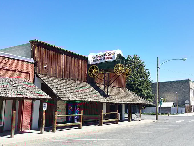 The wagon on the roof isn't just decoration – it's a beacon for hungry travelers. This rustic wooden exterior promises authentic Western dining experiences inside.