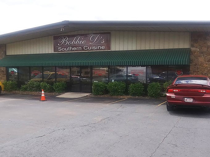 The unassuming exterior of Bobbie D's Southern Cuisine might not scream "culinary destination," but that green awning signals delicious treasures await inside.