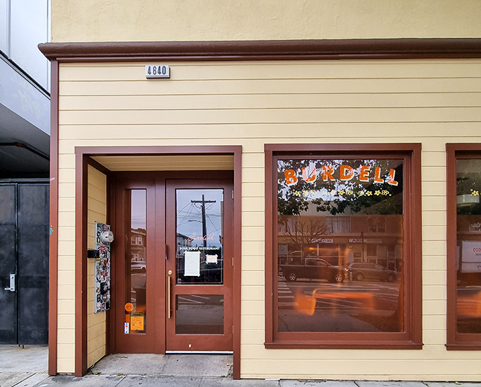 The unassuming cream exterior of Burdell belies the culinary magic happening inside. Like finding a secret doorway to flavor paradise in Oakland.
