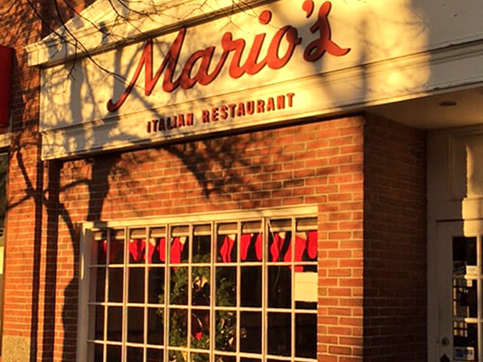 The iconic red script of Mario's against classic brick – like a neon welcome sign for your stomach that's been guiding hungry Lexingtonians for generations.