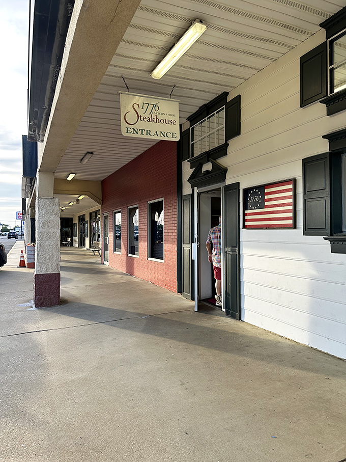 The bold red exterior of 1776 Steakhouse stands as a patriotic beacon for carnivores, promising revolutionary flavors behind those unassuming windows.
