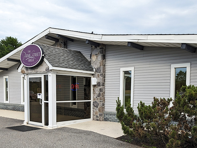 By day, The Prime Street Grille's purple sign stands as a modest beacon of culinary excellence in White Plains, promising steakhouse splendor behind its unassuming exterior.
