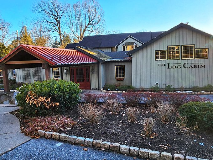 The Log Cabin's exterior glows with warm invitation at twilight, like a beacon of culinary promise in Pennsylvania's countryside.
