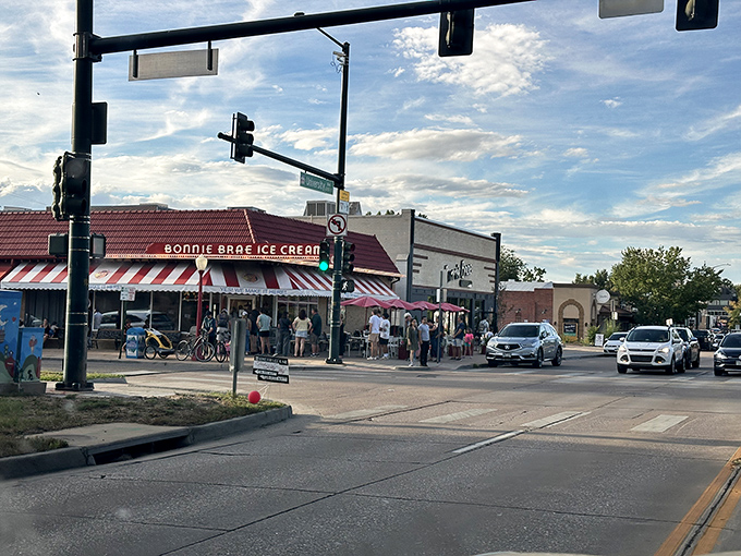 The iconic red-striped awning of Bonnie Brae Ice Cream stands as Denver's beacon of frozen happiness, drawing crowds even on chilly Colorado evenings.