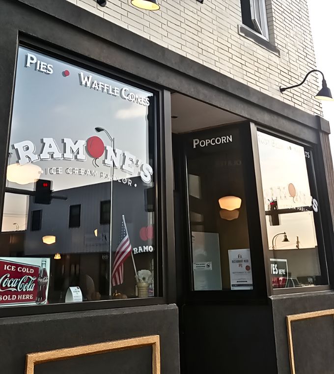 The classic black storefront with that striking red door is like finding the entrance to Willy Wonka's factory hiding in plain sight on a Wisconsin street corner.