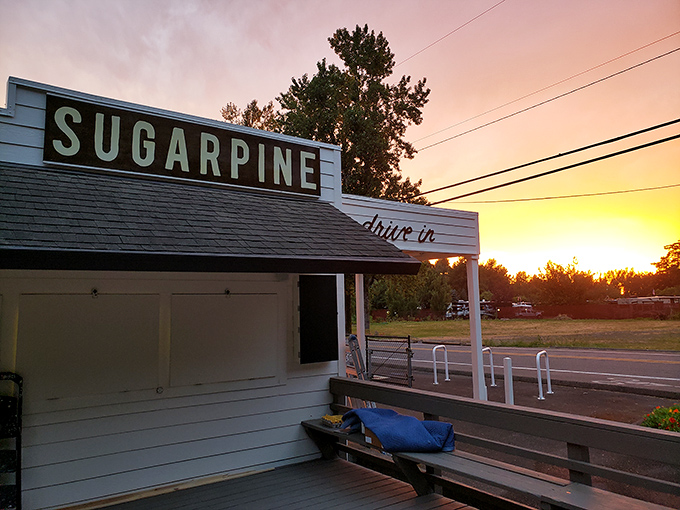 Sugarpine Drive-In's classic white exterior beckons like a mirage in the Oregon wilderness. Nostalgia with a modern twist awaits. 
