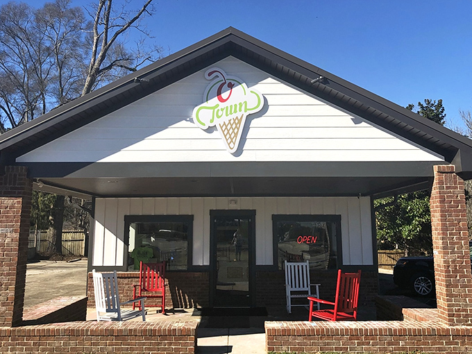 The classic ice cream parlor facade of O Town beckons like a sweet mirage on a hot Alabama day, complete with charming outdoor seating.
