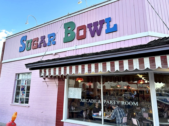 The iconic pink facade of Sugar Bowl stands as a sweet beacon in Old Town Scottsdale, its colorful lettering promising frozen happiness inside.