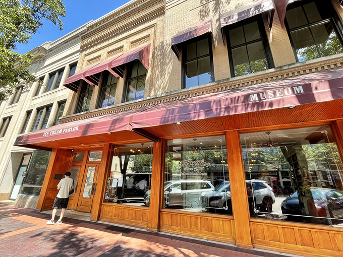 Step back in time with Zaharakos' stunning wooden façade – where the red awnings aren't just decorative, they're practically inviting you in for a sweet escape.