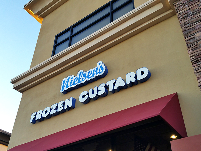 Welcome to frozen custard nirvana! Nielsen's storefront beckons with retro charm and a giant ice cream cone sculpture that's practically winking at you.