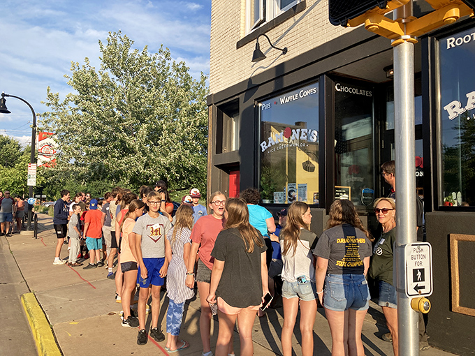 The classic black storefront with that striking red door is like finding the entrance to Willy Wonka's factory hiding in plain sight on a Wisconsin street corner.