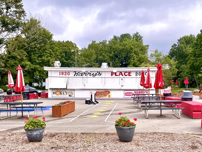 The white facade of Harry's Place stands like a culinary lighthouse, beckoning hungry travelers with its iconic red lettering and promise of roadside bliss.