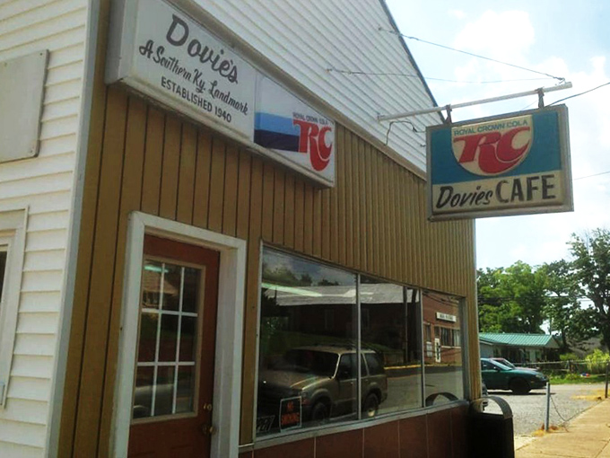The unassuming white exterior of Dovie's stands like a culinary lighthouse in Tompkinsville, beckoning burger pilgrims from across Kentucky's rolling hills.