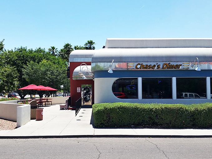 The red and white facade of Chase's Diner shines like a beacon against the Arizona sky, promising comfort food salvation to hungry travelers.