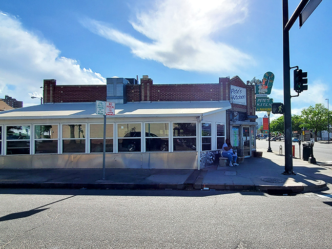 The neon glow of Pete's Kitchen at dusk isn't just a sign&mdash;it's a beacon of hope for hungry souls wandering Colfax Avenue. 