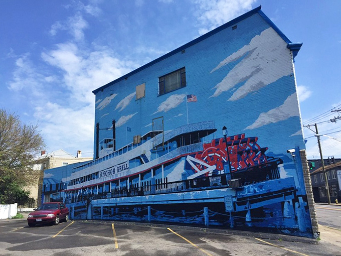 The blue-painted exterior of Anchor Grill features a stunning steamboat mural that's like a maritime welcome committee for hungry travelers.