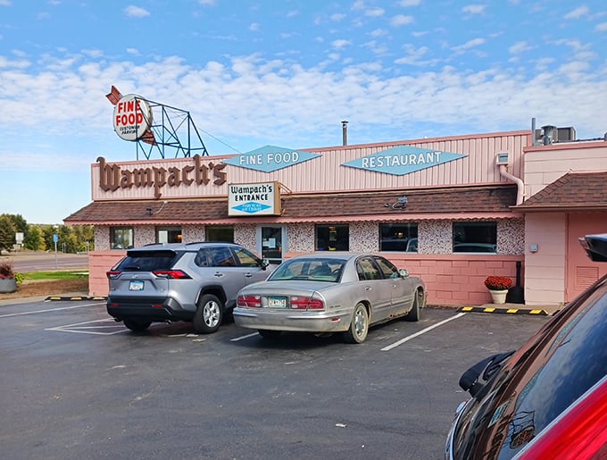 The pink brick facade of Wampach's stands like a time capsule, promising "FINE FOOD" with the confidence of someone who's been keeping that promise for decades.