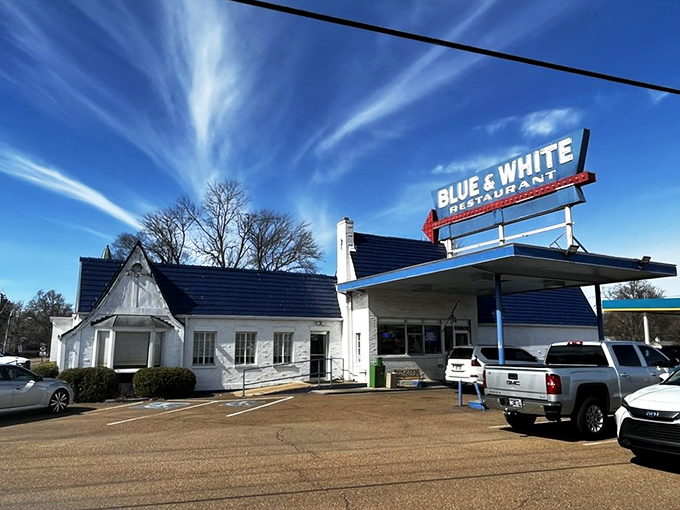 The iconic Blue & White sign beckons hungry travelers like a neon lighthouse on Highway 61. This classic roadside architecture promises comfort food and Mississippi hospitality.