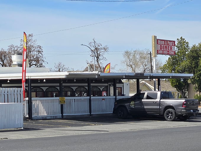 The classic red and white sign beckons like a lighthouse for hungry travelers. Mom and Pop's Diner isn't just a place&mdash;it's a promise of comfort ahead.