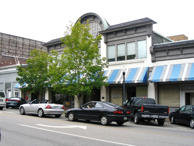 Historic storefronts with classic blue awnings create that perfect small-town ambiance where your dollar stretches further than your weekend plans.