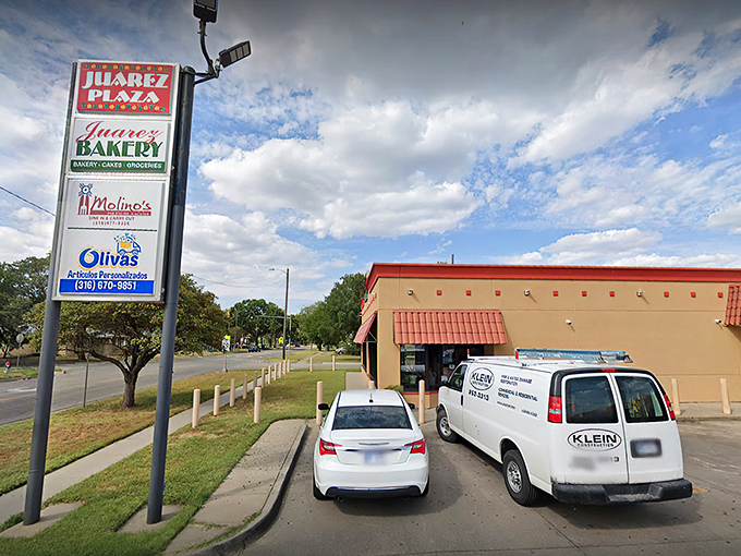 The tan building with striking red awnings beckons like a lighthouse for carb enthusiasts. One glance at that "OPEN" sign and resistance becomes futile.