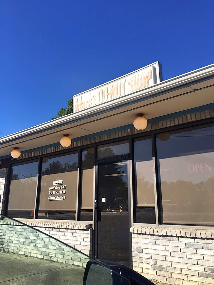 The unassuming storefront where donut dreams come true. Blue skies above, sweet treasures within&mdash;North Little Rock's hidden gem awaits.