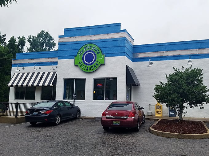 The blue and white exterior of The Blue Plate stands out like a beacon of hope for hungry travelers. This unassuming building holds culinary treasures within.