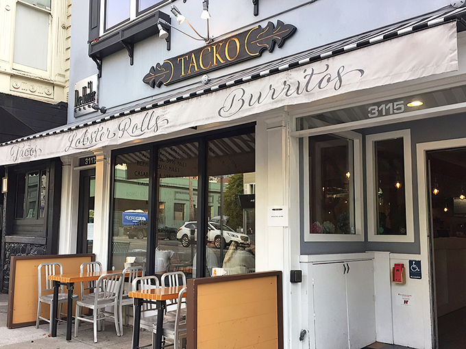 The iconic Tacko storefront proudly announces its dual culinary citizenship with "Tacos," "Lobster Rolls," and "Burritos" emblazoned on its cheerful awning.