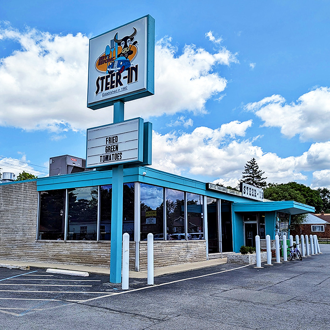 The turquoise beacon of Steer-In stands proudly against an Indiana sky, promising comfort food salvation to hungry Indianapolis souls.