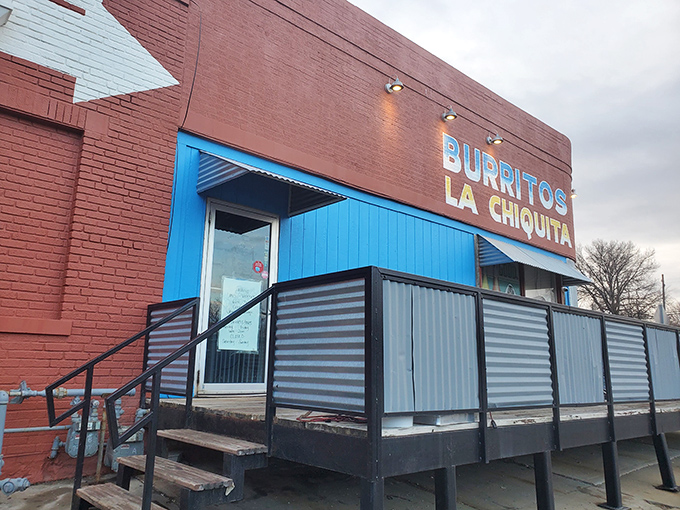The bright blue entrance against brick-red walls isn't just eye-catching&mdash;it's a beacon for burrito lovers across Kansas City. No fancy frills, just fantastic food awaiting inside.