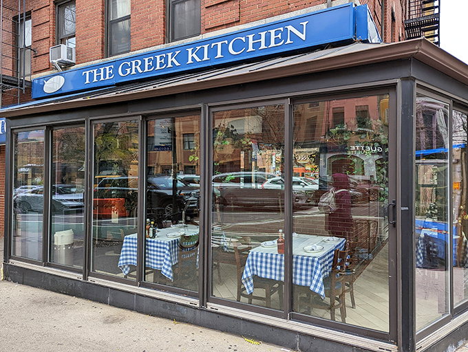 The blue awning of The Greek Kitchen beckons like a Mediterranean oasis amid Manhattan's brick landscape. Your Aegean adventure awaits!