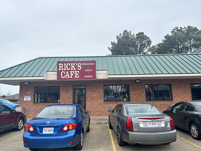 The unassuming brick exterior of Rick's Cafe stands like a culinary lighthouse, its green roof and straightforward signage promising honest food without pretense.