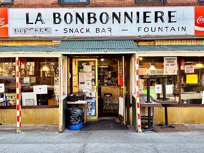 La Bonbonniere's weathered fa&ccedil;ade stands as a time capsule in the West Village, its vintage sign promising the holy trinity of comfort: burgers, snacks, and fountain treats.