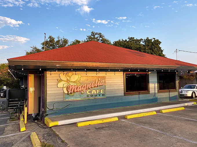 The iconic blue exterior of Magnolia Cafe stands as an Austin landmark, its welcoming porch and signature sign beckoning hungry pilgrims at all hours.