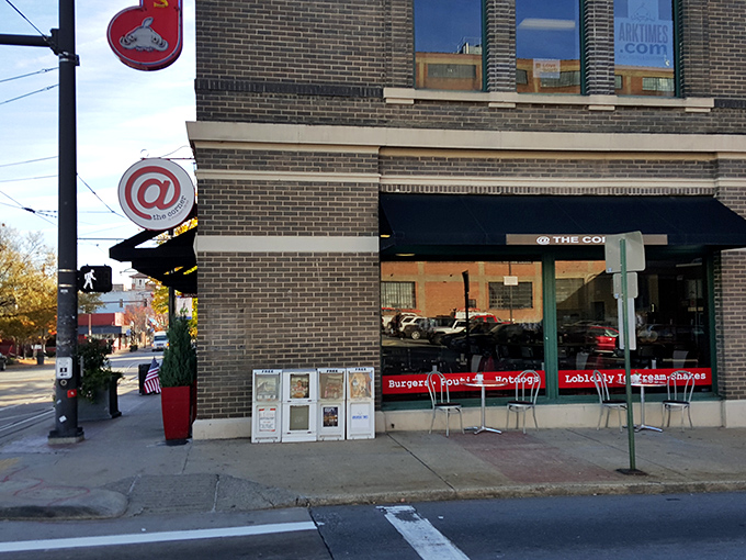 The iconic red and white circular sign beckons hungry travelers to this brick corner building, promising comfort food with urban style.