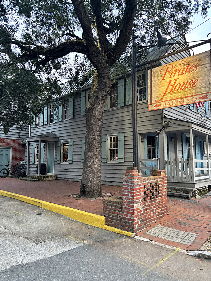 The historic blue-shuttered facade of The Pirates' House stands as a Georgian time capsule, welcoming hungry travelers just as it has since 1753.