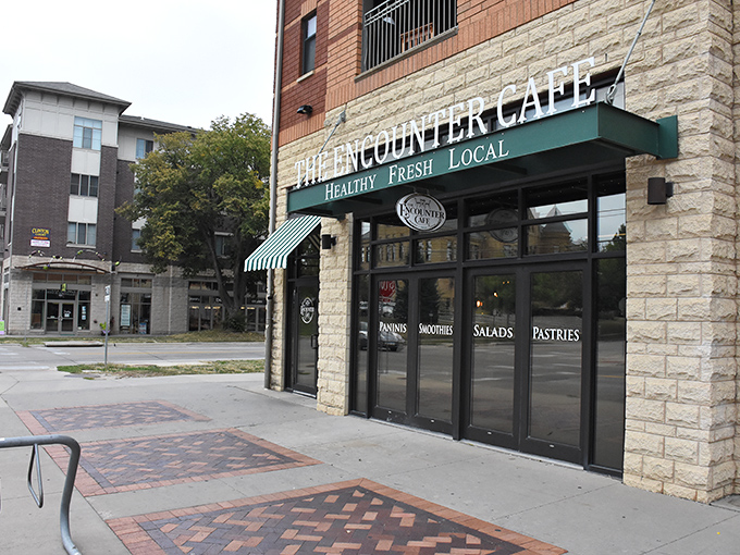 The perfect corner cafe doesn't announce itself with neon signs—just green and white awnings that whisper, "Come inside, the French toast is waiting."
