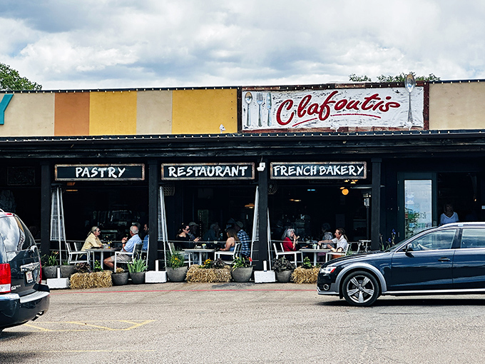 The unassuming exterior of Clafoutis beckons like a French postcard come to life, complete with charming patio seating perfect for people-watching with your pain au chocolat.