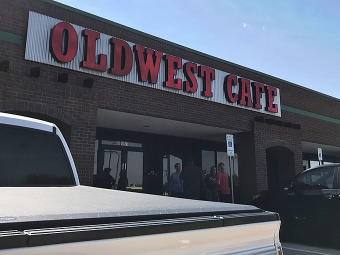 The bold red letters against corrugated metal announce Oldwest Cafe like a breakfast beacon. No fancy frills needed when what's inside speaks volumes.