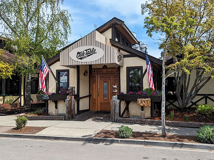 The entrance to breakfast paradise! Wooden bears stand guard at The Oak Table Cafe's doorway, promising a Pacific Northwest dining experience worth waking up for.