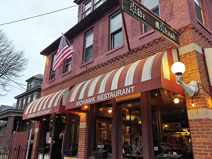 The iconic red and white striped awning of The Old Mohawk beckons like a culinary lighthouse in Columbus's charming German Village. Resistance is futile.