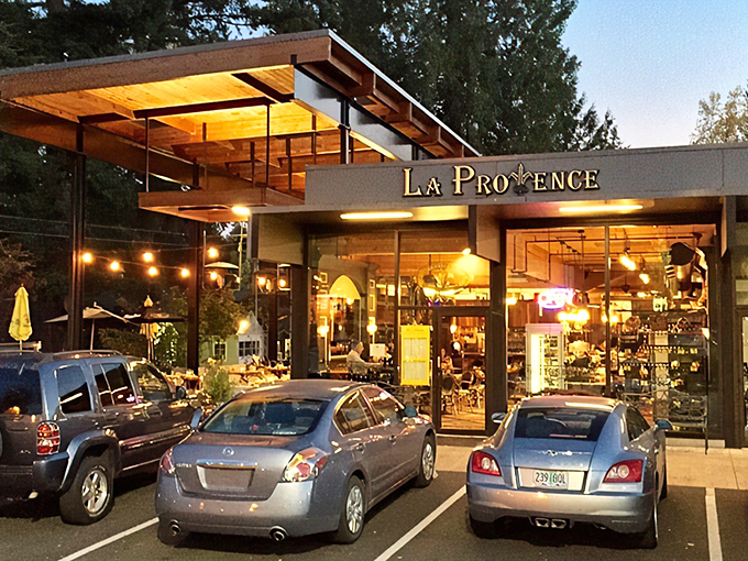 La Provence glows like a beacon of French culinary promise at dusk, its warm lights beckoning hungry Oregonians from miles around. 