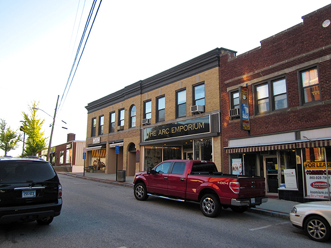 Downtown Putnam at golden hour &ndash; where historic brick buildings and leafy trees create that perfect small-town tableau Norman Rockwell would've painted in a heartbeat.