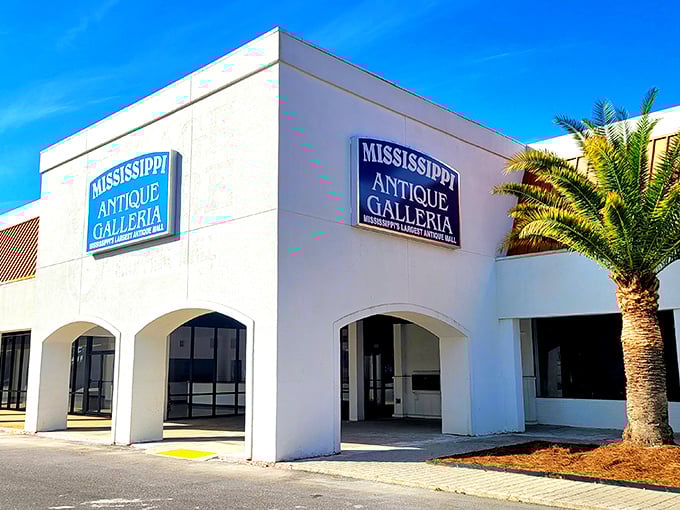 The classic car parked outside isn't just decoration—it's a time machine preview of the wonders waiting inside Mississippi Antique Galleria.