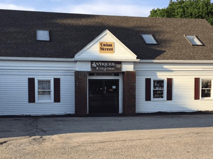 The unassuming exterior of Union Street Antiques beckons with its yellow sign and classic New England charm—a time portal disguised as a simple white building.