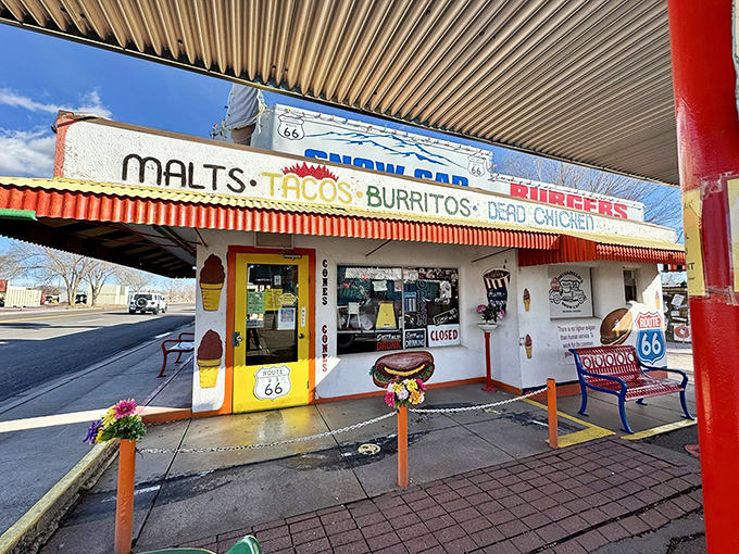 Route 66 nostalgia meets carnival funhouse at Delgadillo's Snow Cap, where even the vintage car out front refuses to take itself seriously.