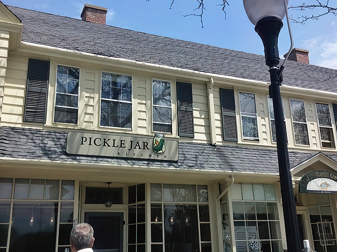 The charming yellow exterior of Pickle Jar Kitchen beckons like a culinary lighthouse on Falmouth's Main Street, promising comfort and creativity inside.