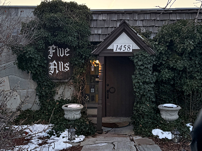 The entrance to Five Alls feels like a portal to medieval England, complete with ivy-covered walls and a door that practically begs you to say "Open sesame!"