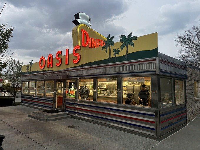 The sunshine-yellow exterior of Oasis Diner beckons like a time portal to the 1950s, complete with palm trees that seem hilariously optimistic in Indiana weather.