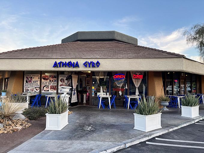 The blue glow of Athena Gyro's sign beckons like a Mediterranean lighthouse in the desert night, promising authentic Greek flavors behind those welcoming doors.